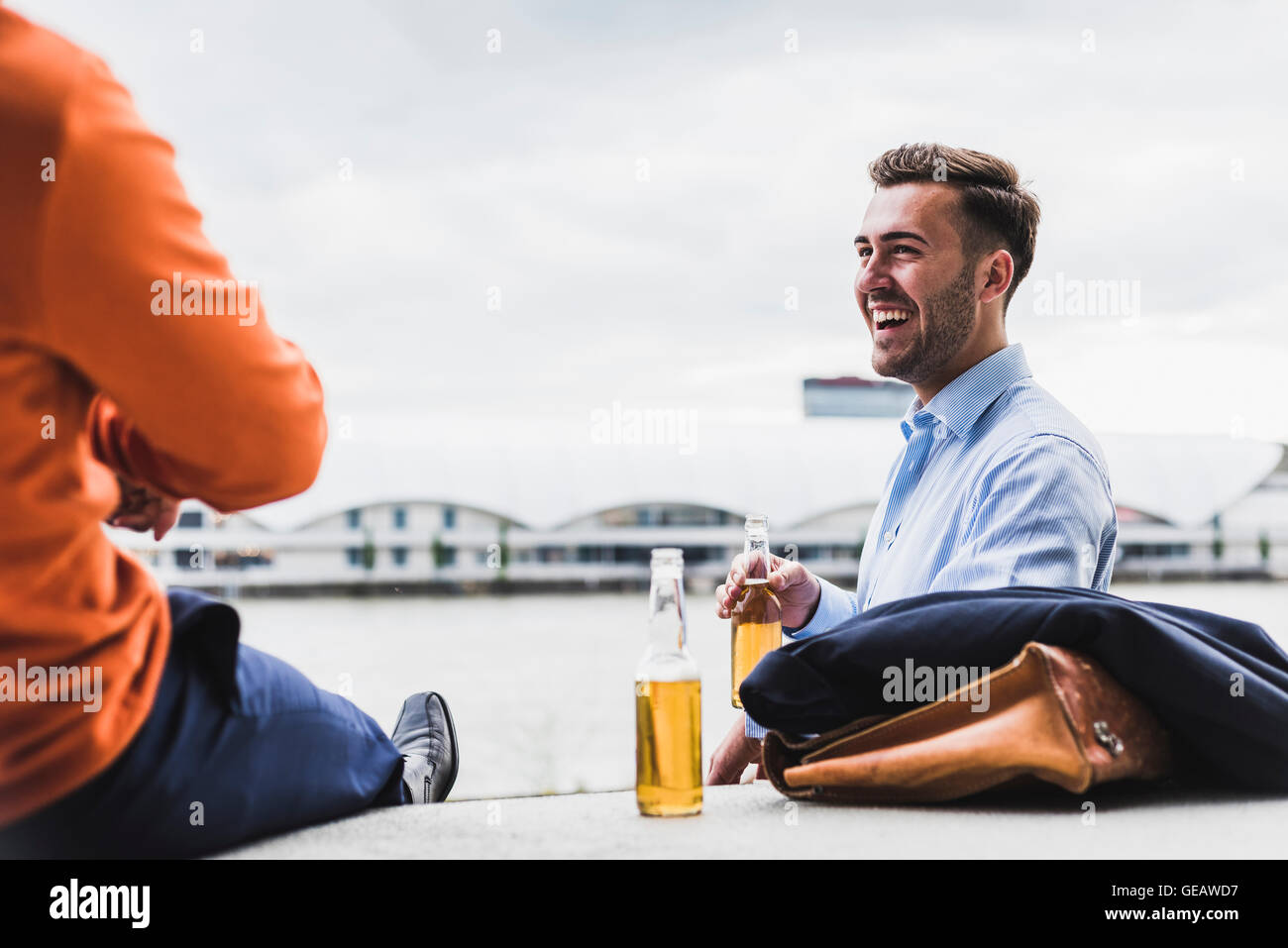 Two colleagues having a beer after work Stock Photo - Alamy