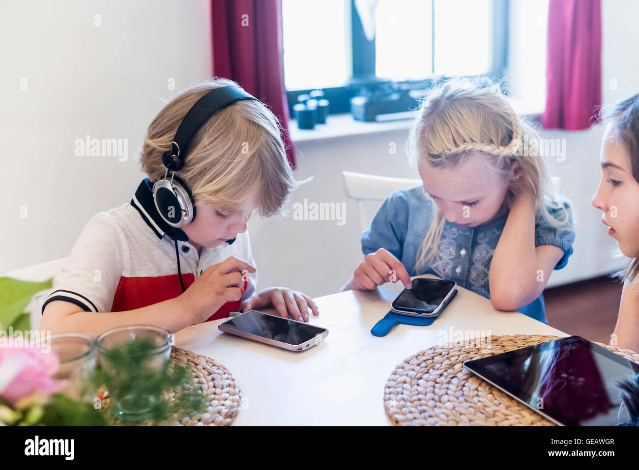 Three children with mobile devices Stock Photo - Alamy