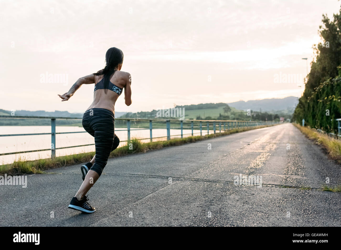 Woman running outdoors Stock Photo - Alamy