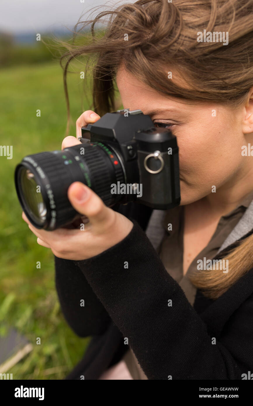 Woman photographing in nature Stock Photo - Alamy