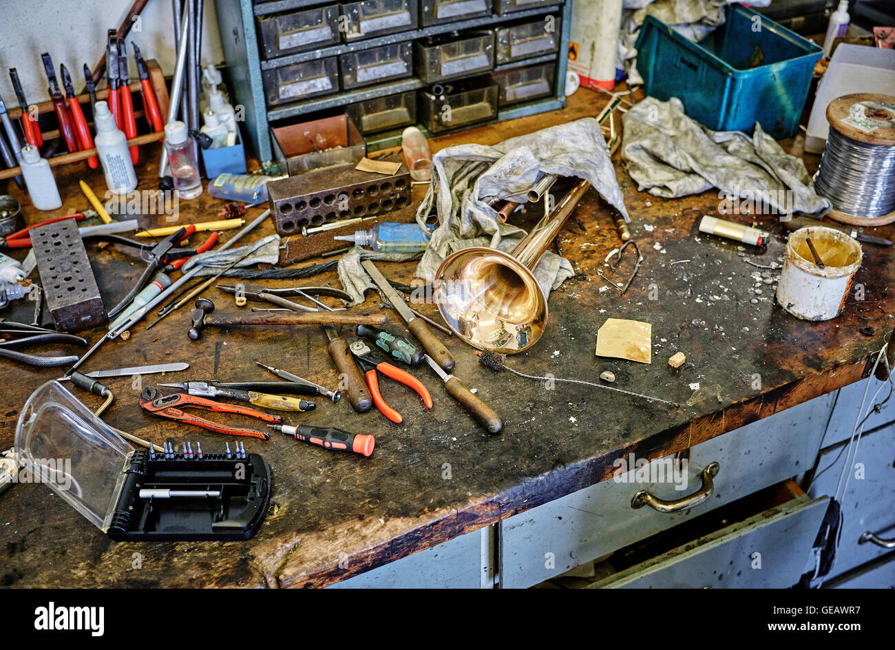 Workbench of an instrument maker with tools and trumpet Stock Photo - Alamy