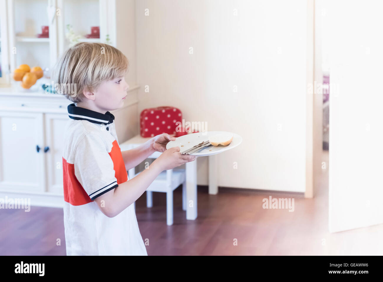 Boy carrying plate Stock Photo - Alamy