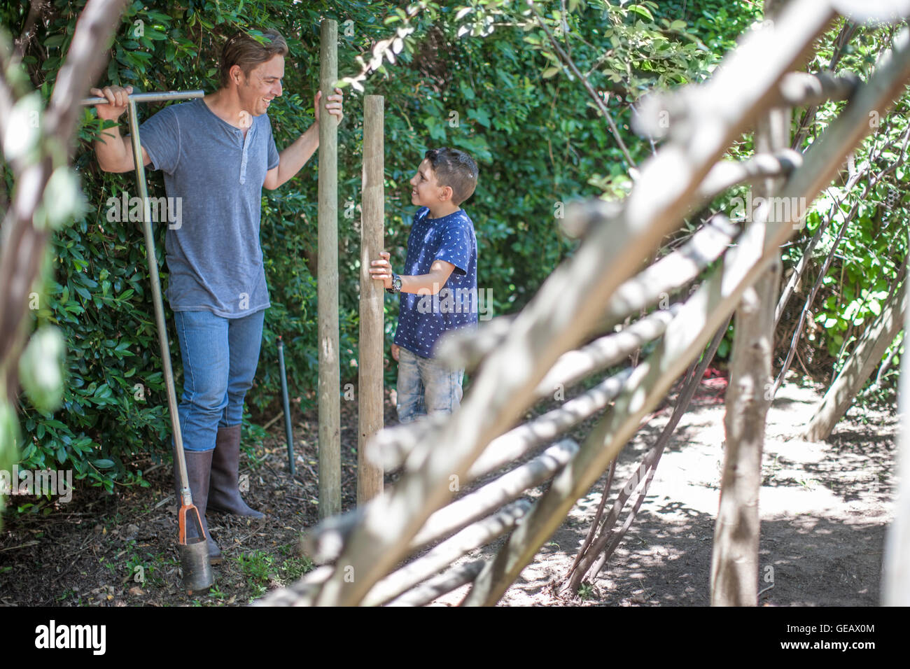 Father and son working together in garden Stock Photo - Alamy