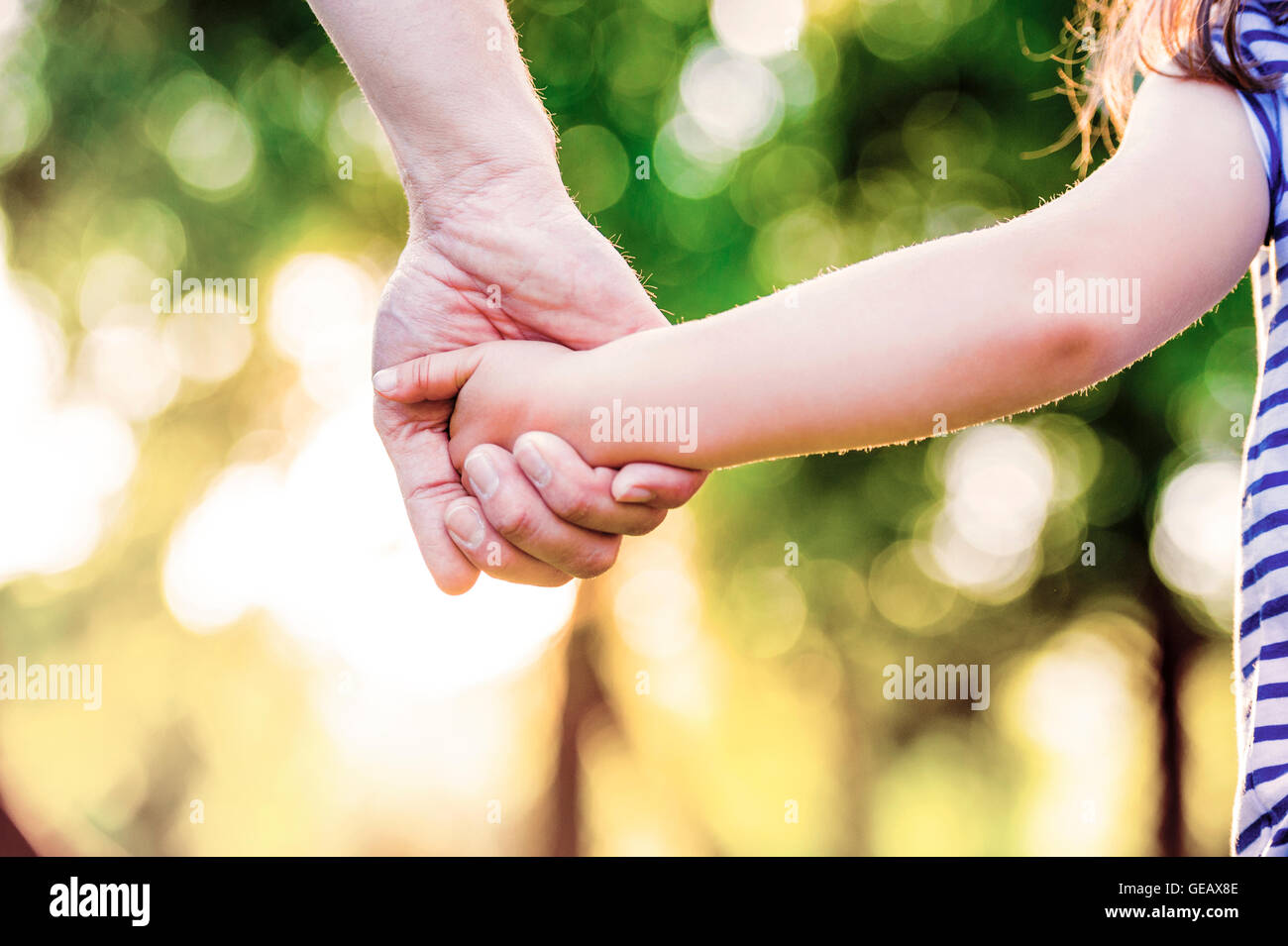 Father holding hand of his little daughter Stock Photo - Alamy
