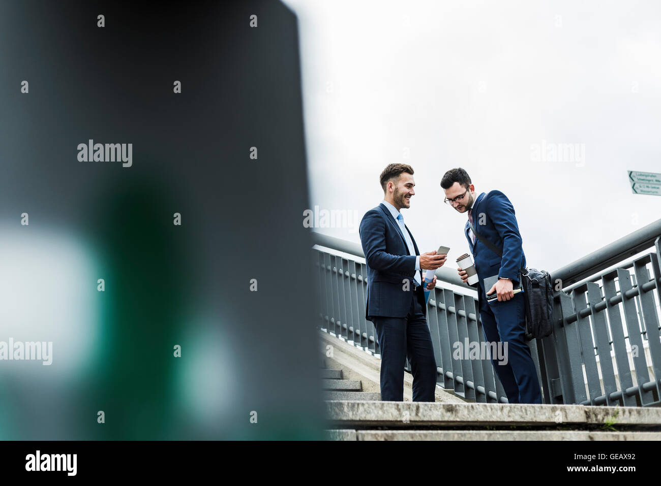 Two businessman talking in the city Stock Photo - Alamy