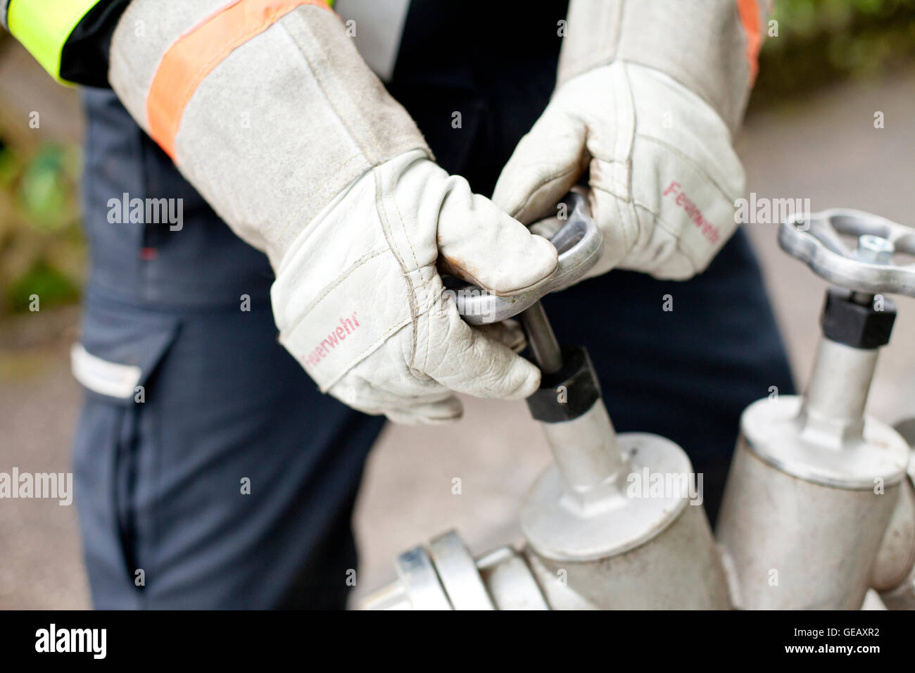 Close-up of firefighter opening fire hydrant Stock Photo - Alamy