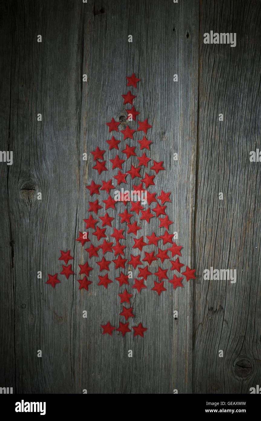 Red stars shaped like a Christmas tree on wood Stock Photo - Alamy