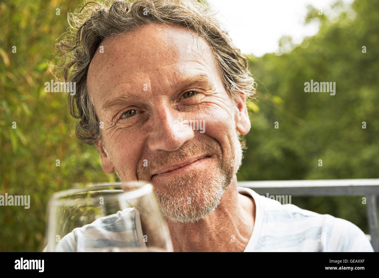 Portrait of happy man toasting with wine glass Stock Photo - Alamy