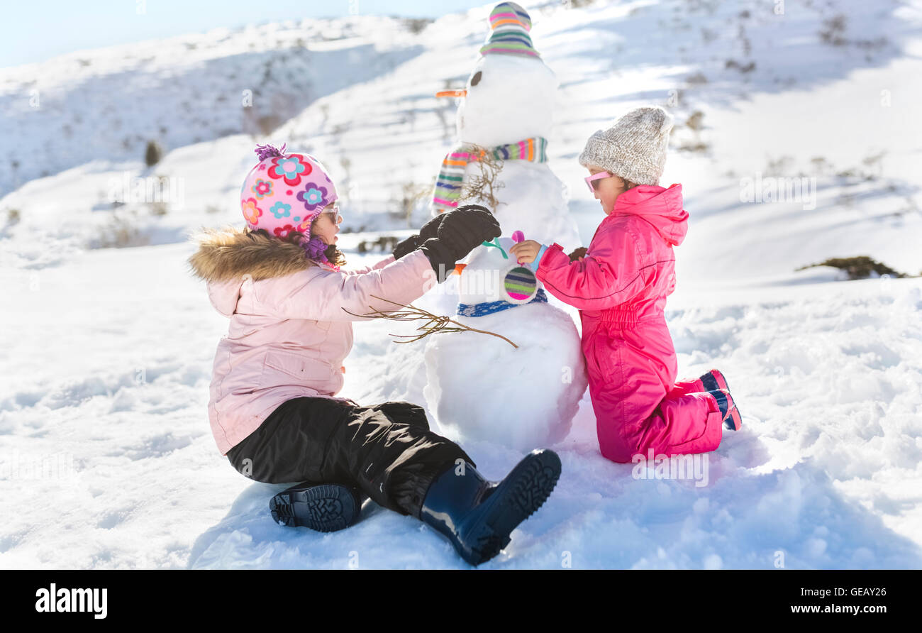 Spain, Asturias, kids playing with snowmen in a snowy mountains Stock ...
