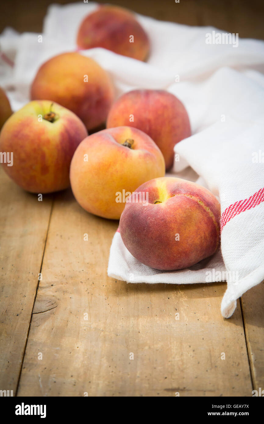 Peaches and cloth on wood Stock Photo - Alamy