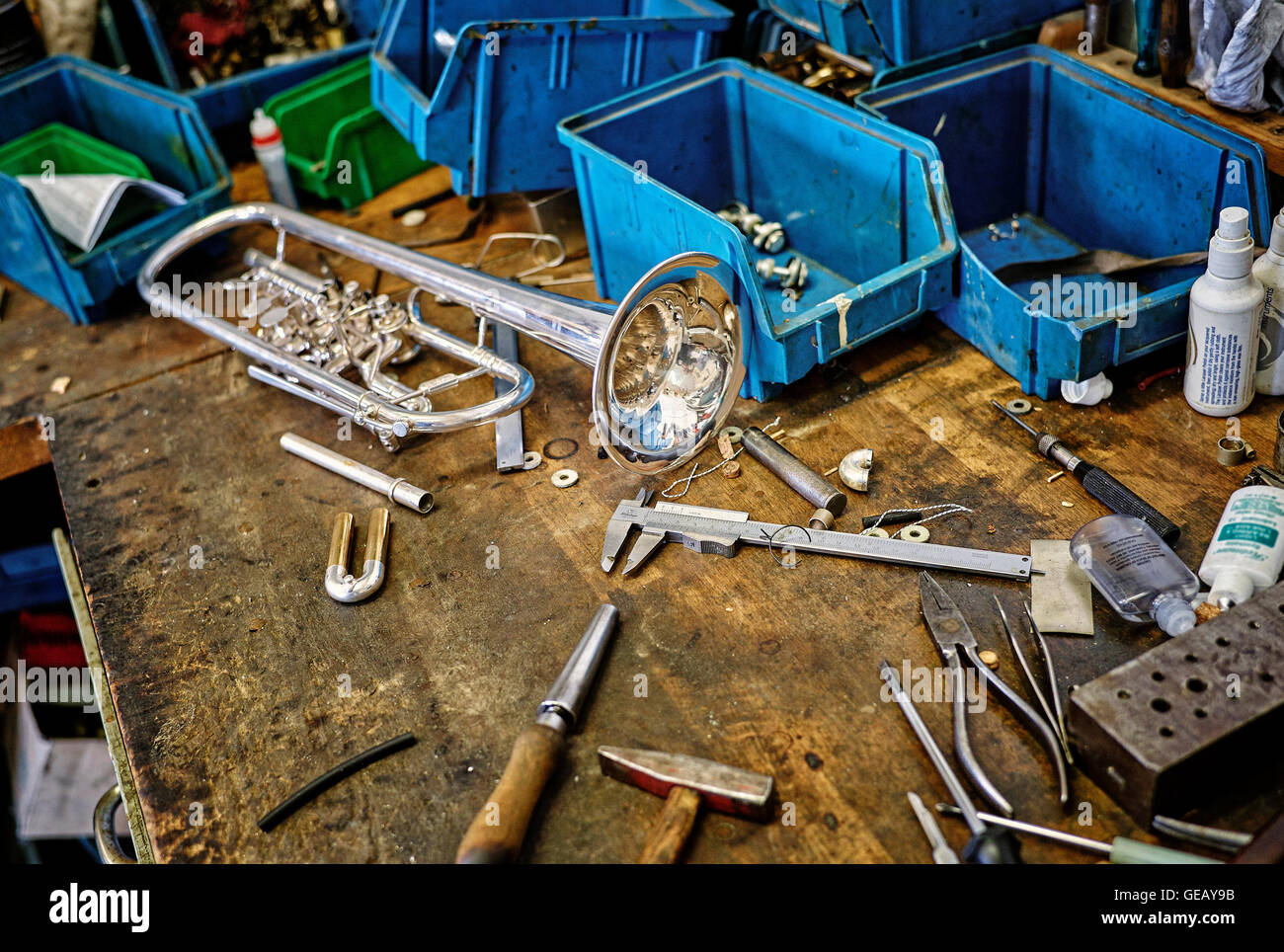 Workbench of an instrument maker with tools and trumpet Stock Photo - Alamy