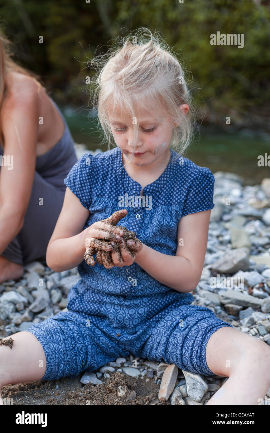 Portrait of little girl playing at riverside Stock Photo - Alamy