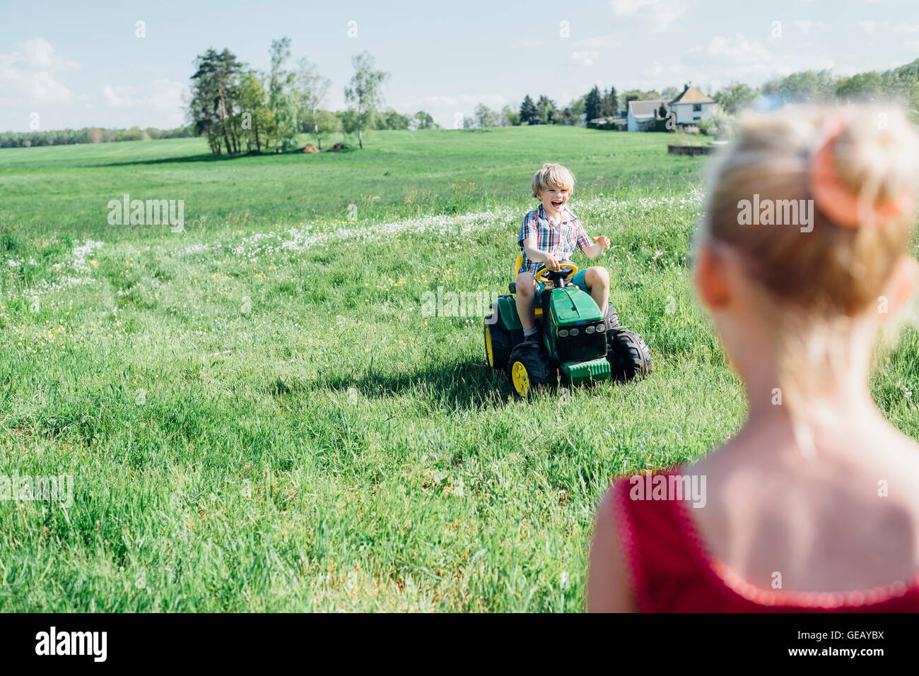 Boy riding toy tractor hi-res stock photography and images - Alamy