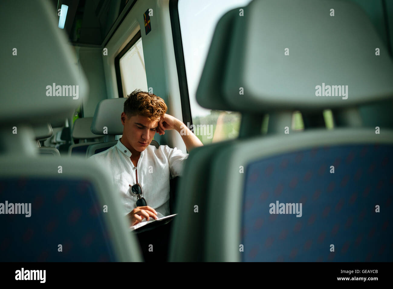 Man sitting on a train hi-res stock photography and images - Alamy