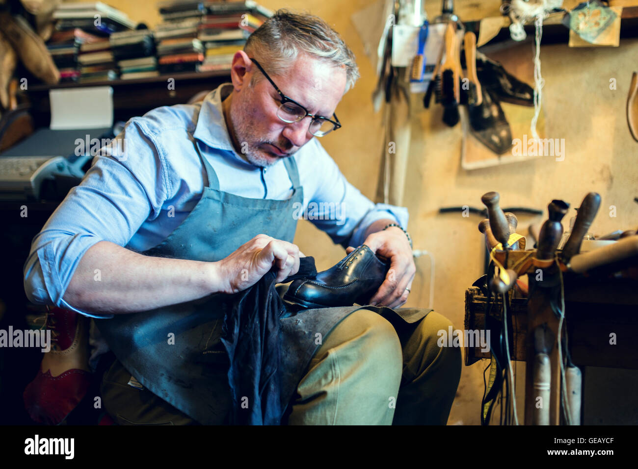 Cobbler making shoes in his workshop Stock Photo - Alamy