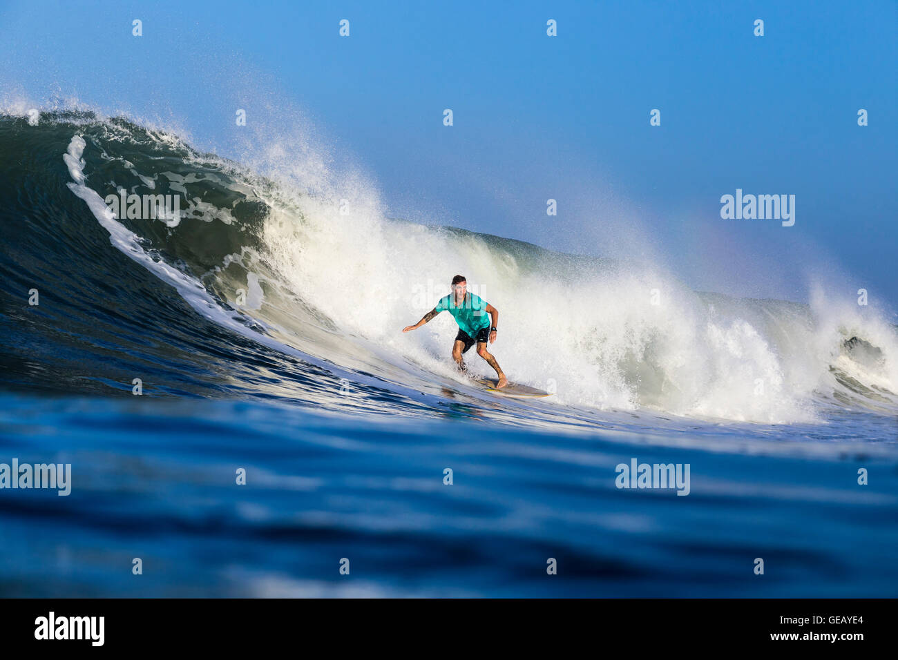 Surfing a wave Stock Photo - Alamy