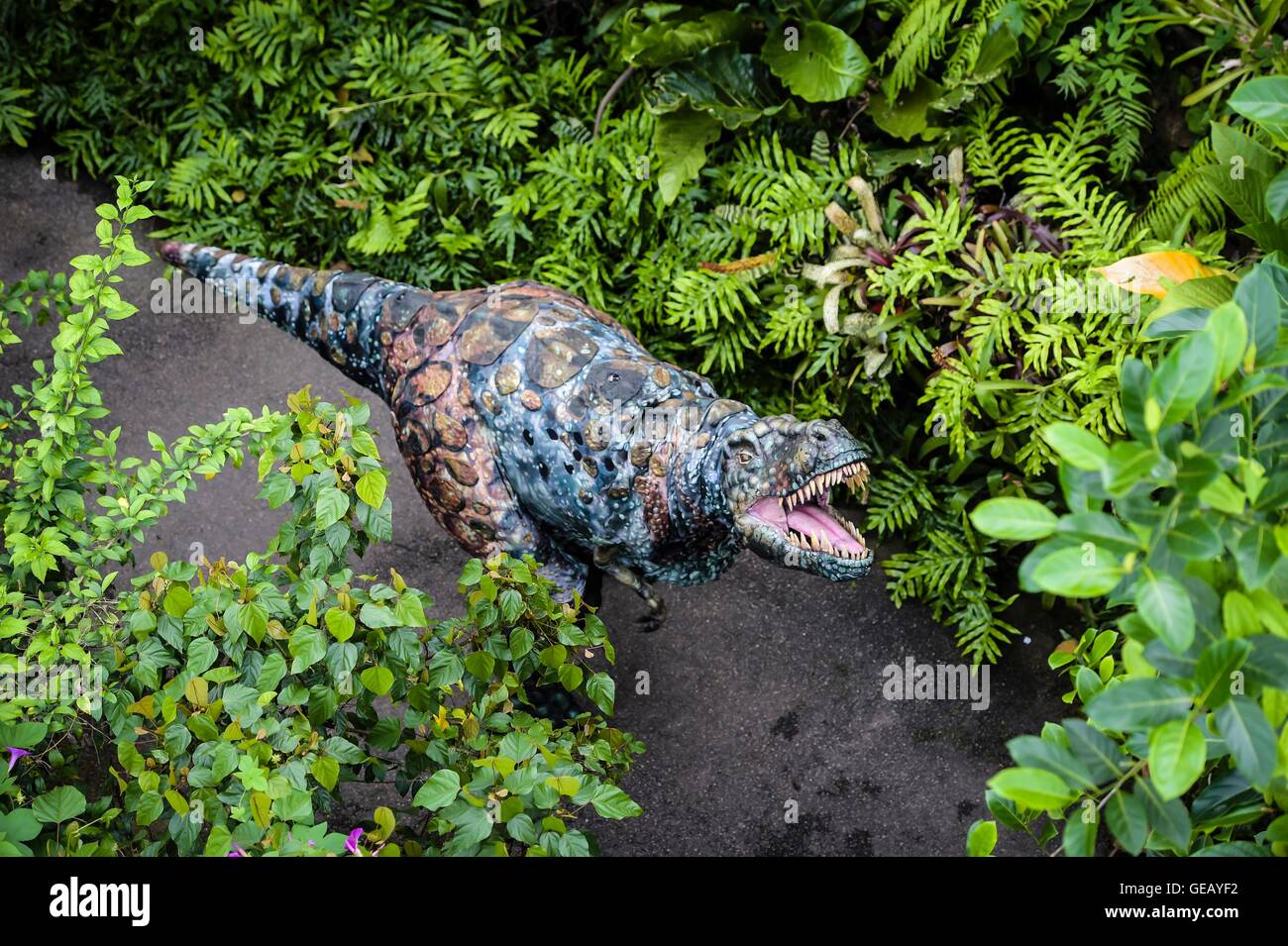 A human-operated puppet of a T-Rex dinosaur wanders around inside the ...