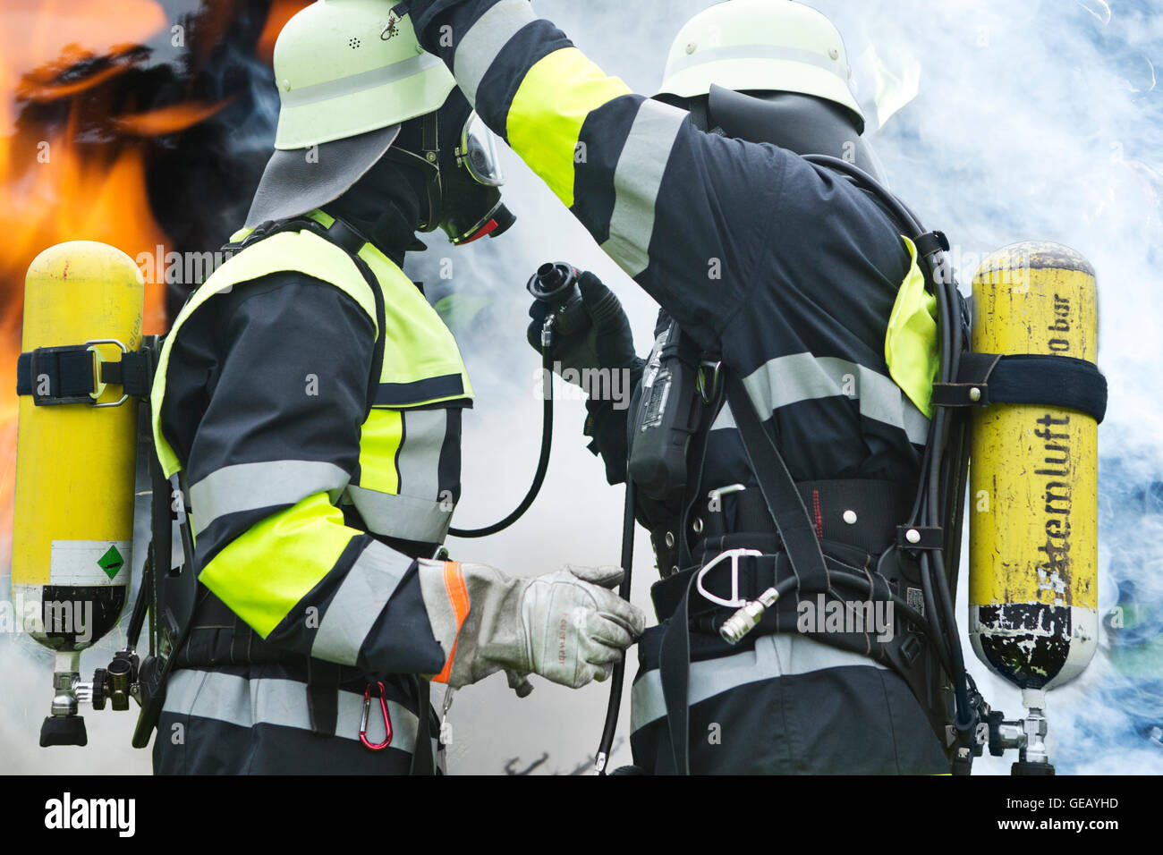 Two firefighters preparing operation Stock Photo - Alamy