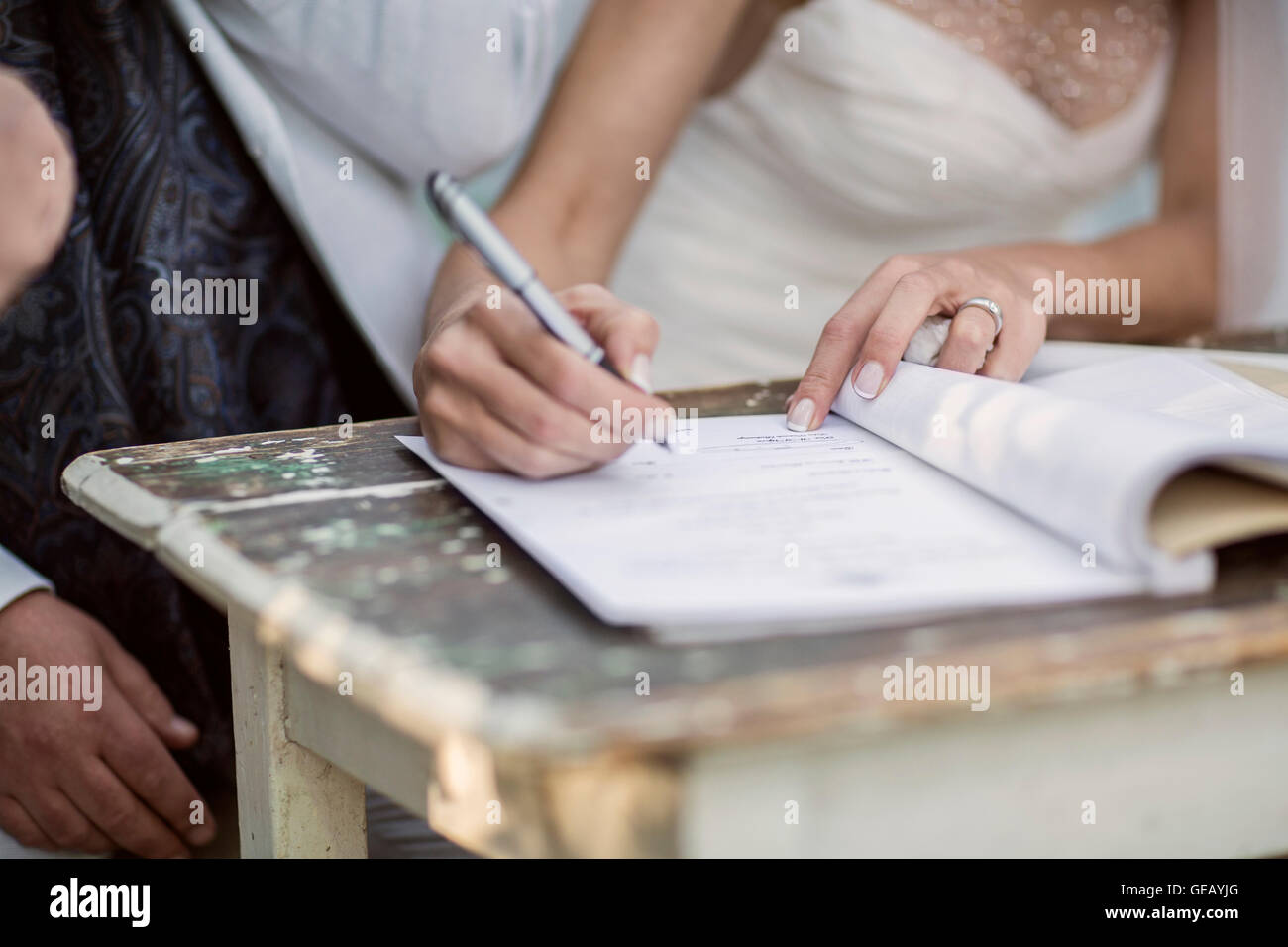 Caucasian hand signing marriage hi-res stock photography and images - Alamy