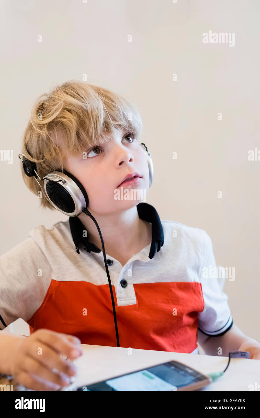Boy wearing headphones looking up Stock Photo - Alamy