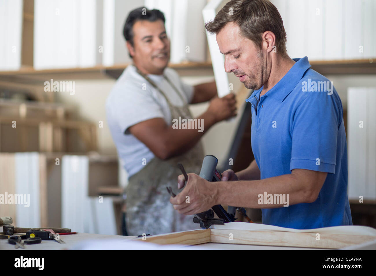 Two men working in canvas workshop Stock Photo - Alamy