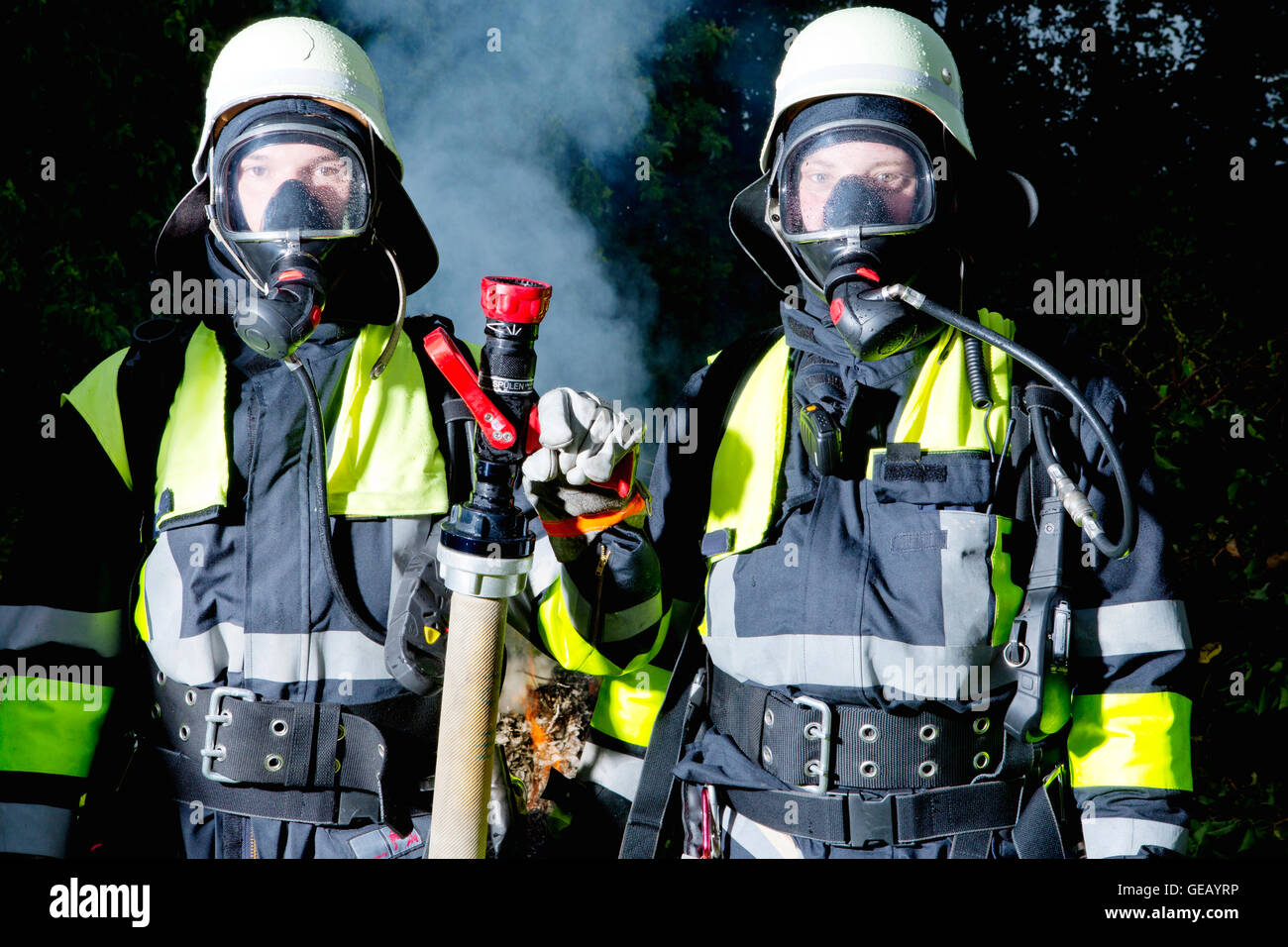 Two firefighters in uniform Stock Photo - Alamy