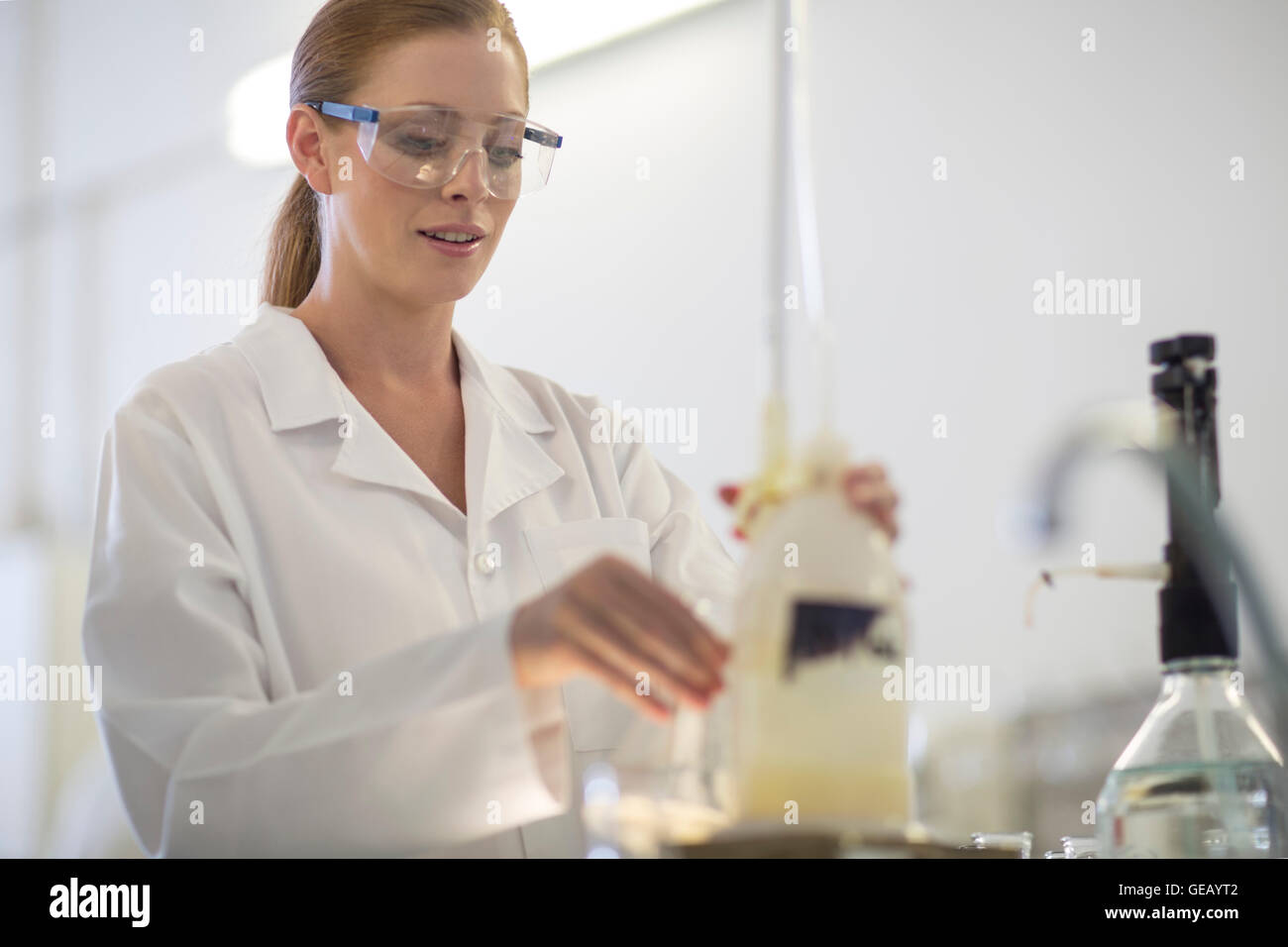 Young woman working in lab Stock Photo - Alamy