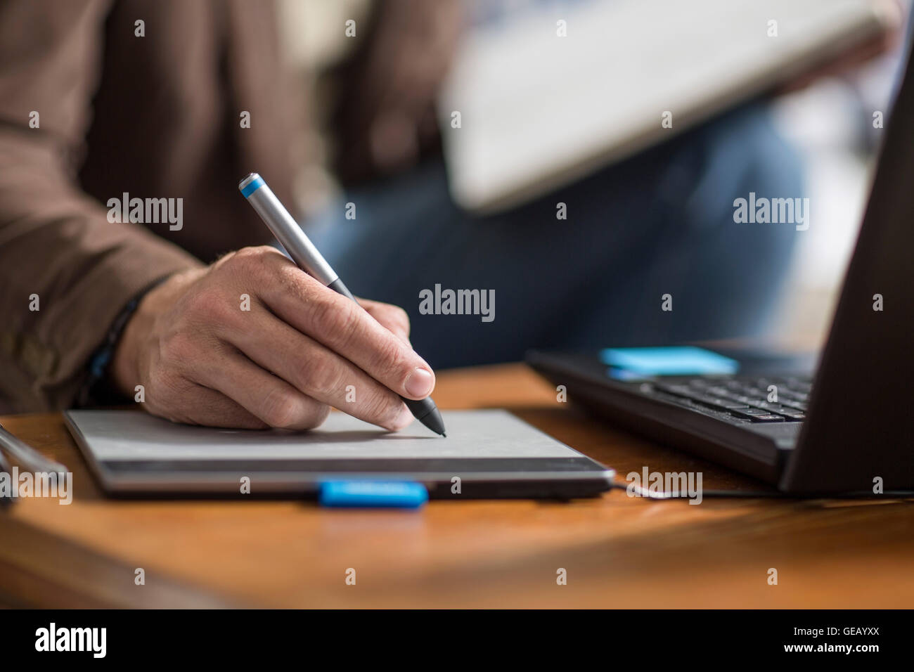Hand of graphic designer, graphics tablet and pencil Stock Photo - Alamy