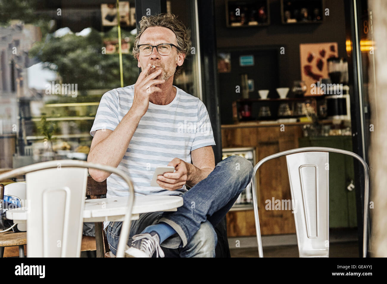 Man smoking at a cafe hi-res stock photography and images - Alamy