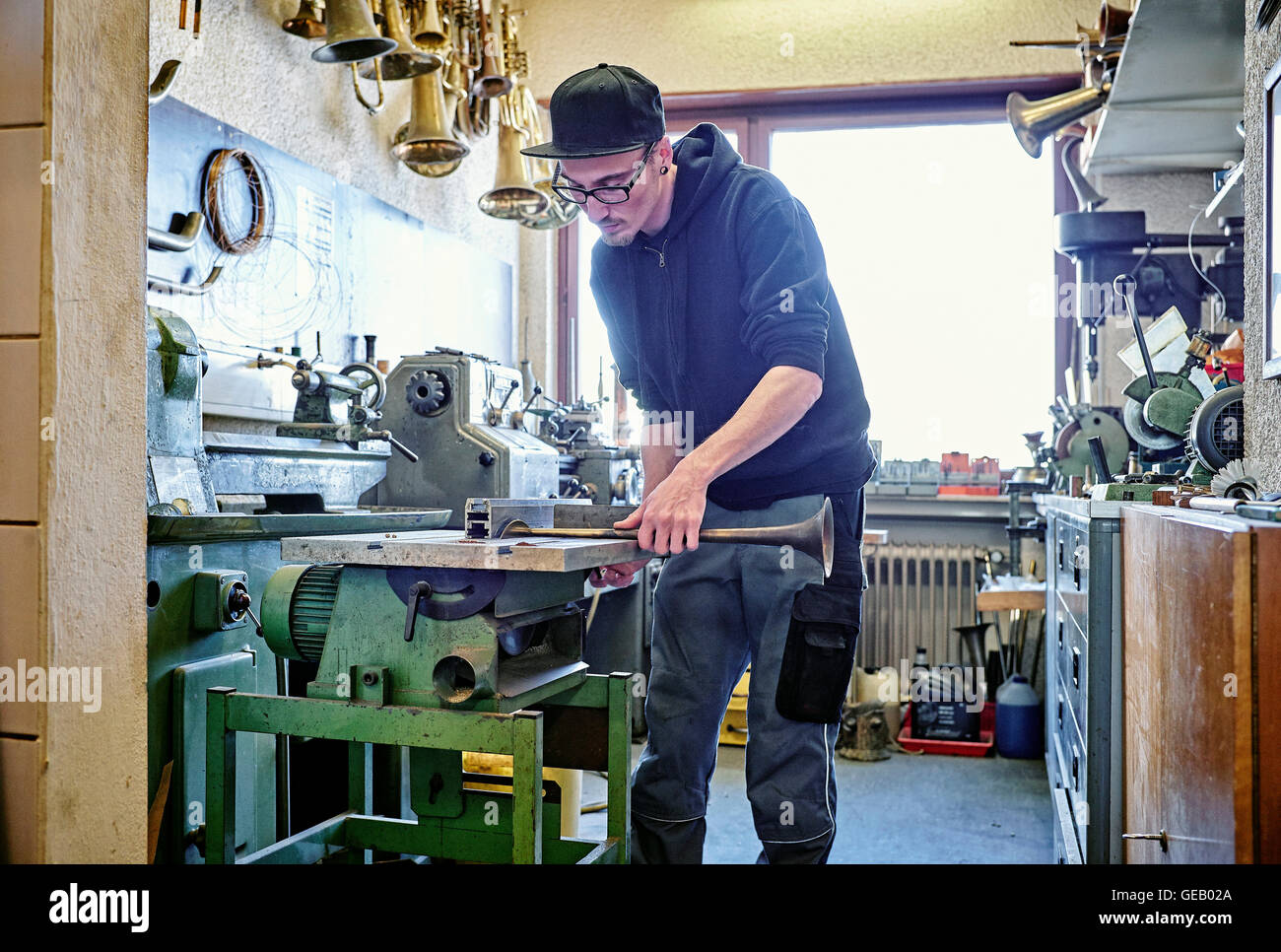 Instrument maker making trumpet in workshop Stock Photo - Alamy