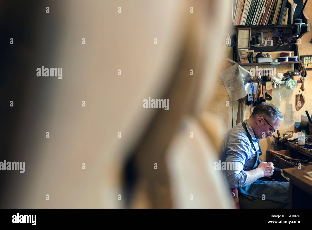 Cobbler making shoes in his workshop Stock Photo - Alamy
