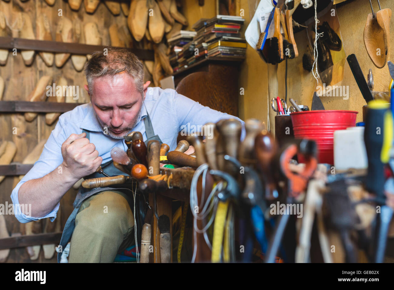 Cobbler making shoes in his workshop Stock Photo - Alamy