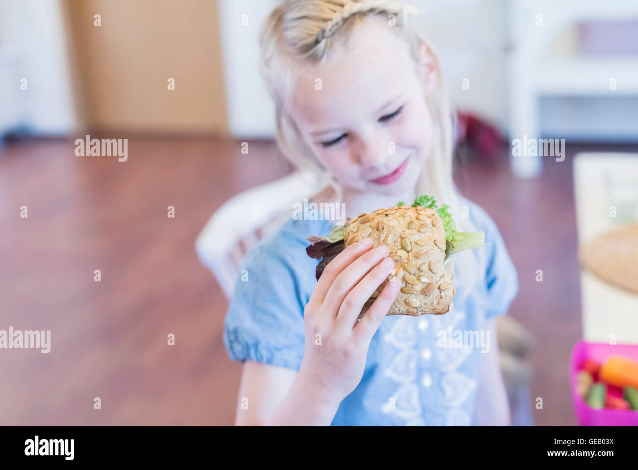Girl holding bread roll Stock Photo - Alamy