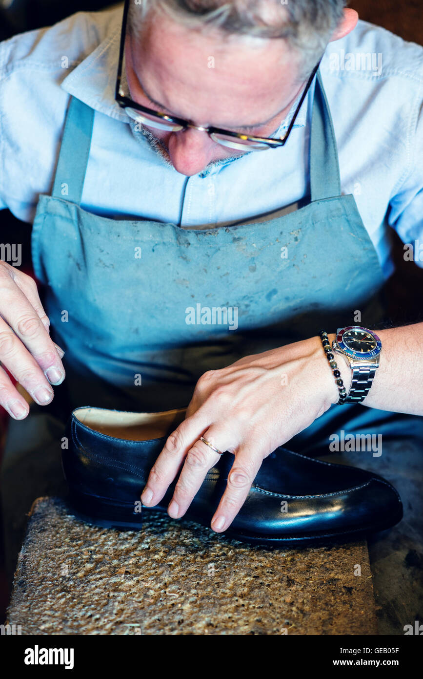 Cobbler making shoes in his workshop Stock Photo - Alamy