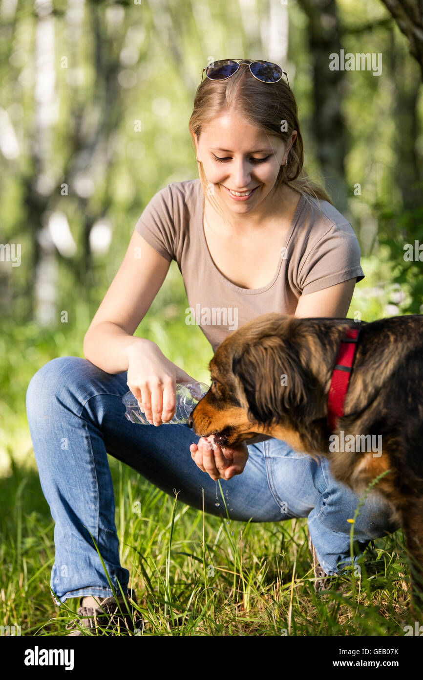 Woman giving water dog hi-res stock photography and images - Alamy