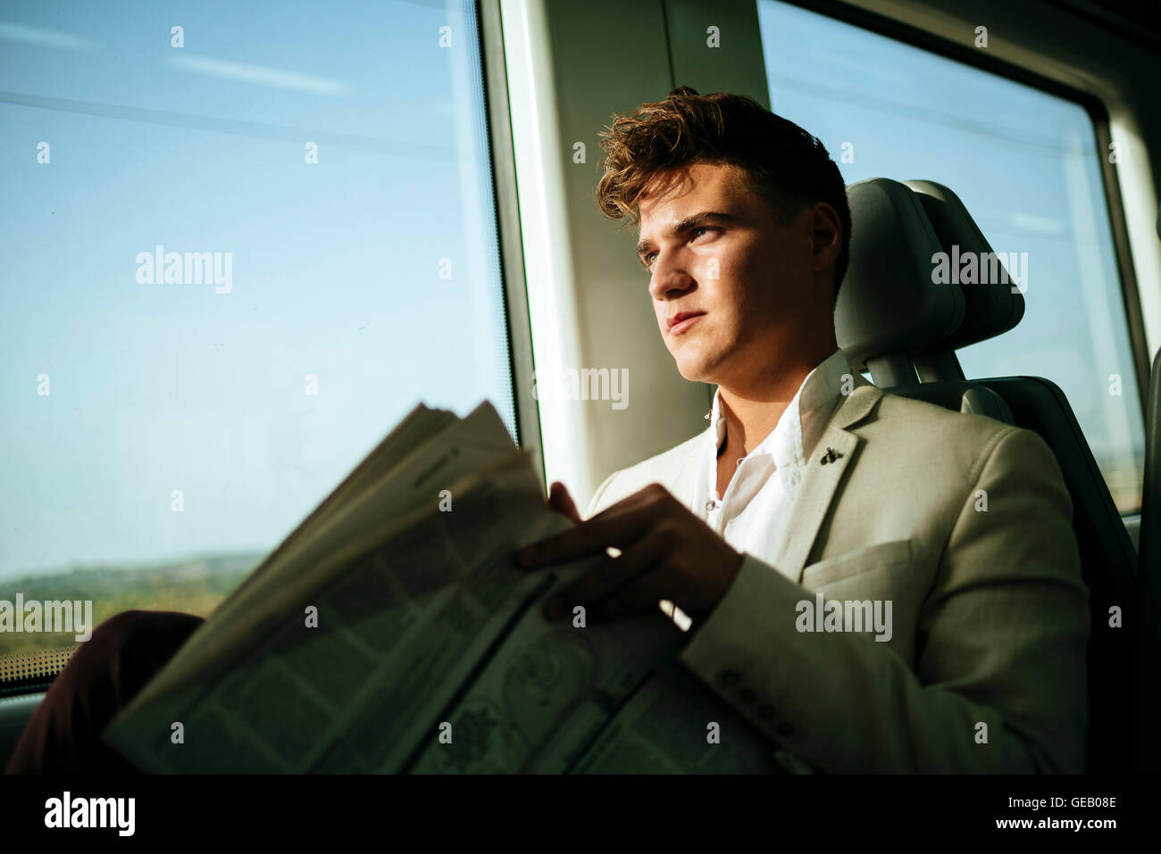 Man train reading newspaper hi-res stock photography and images - Alamy