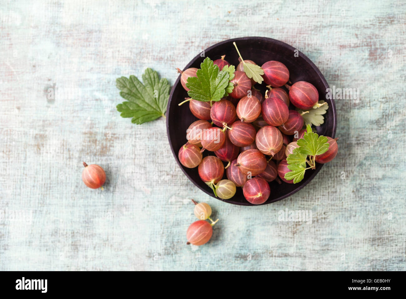 Bowl of red gooseberries Stock Photo - Alamy