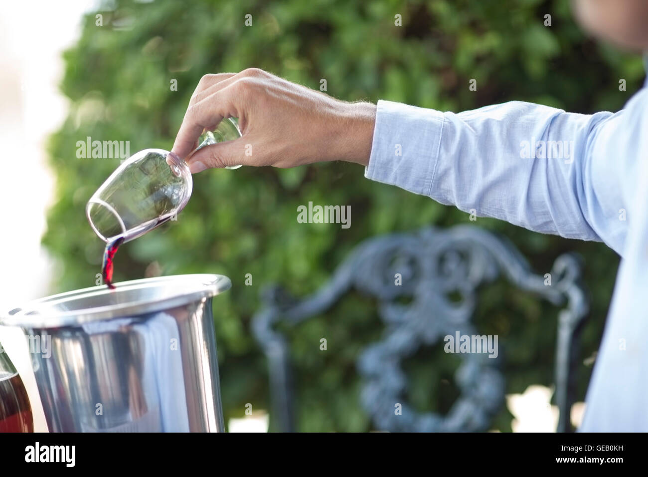 Man pouring out glass of red wine Stock Photo - Alamy