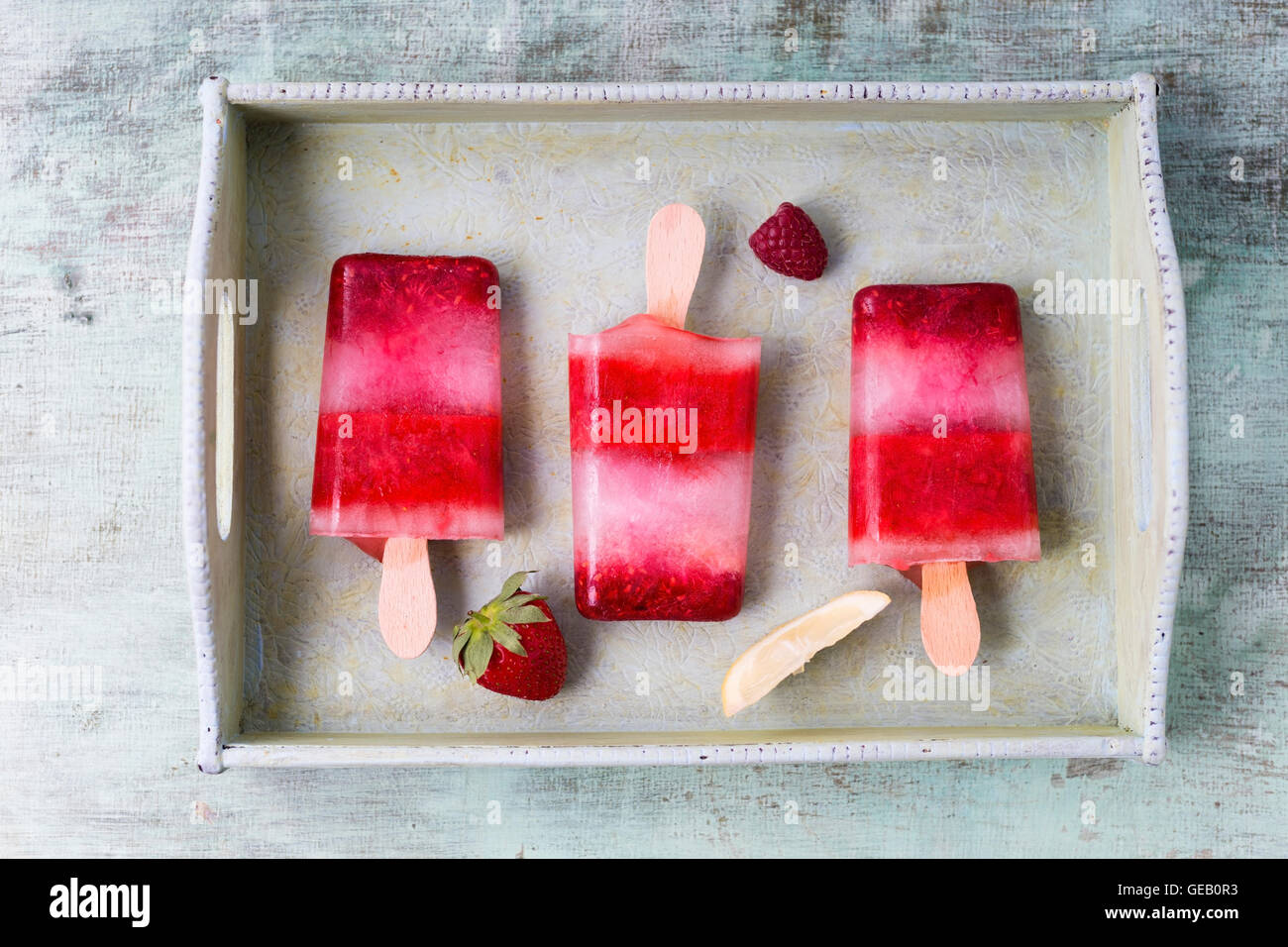 Homemade strawberry raspberry lemon ice lollies on tray Stock Photo - Alamy