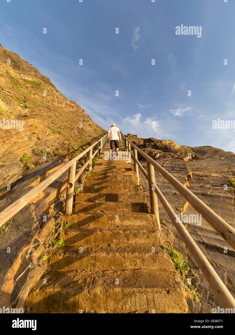 Portugal, Senior man climbing stairs, rear view Stock Photo - Alamy