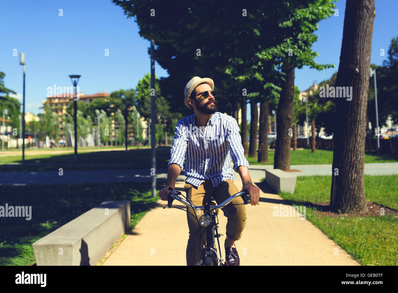 Young man riding bicycle Stock Photo - Alamy