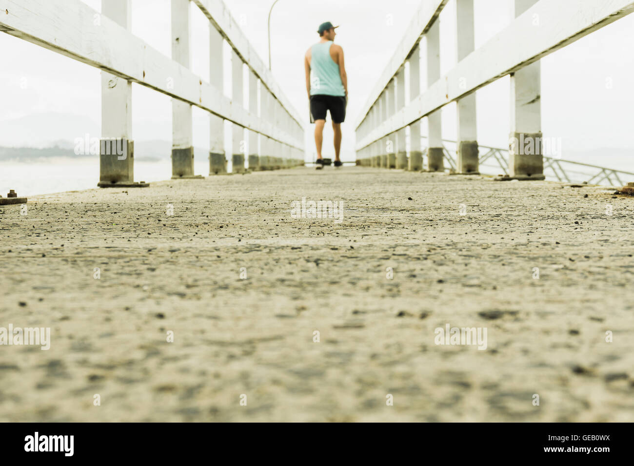 Back view of man on a jetty Stock Photo - Alamy