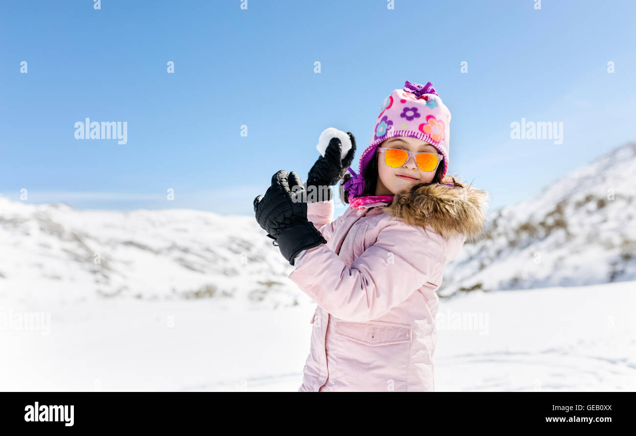 Girl throwing snowball Stock Photo - Alamy