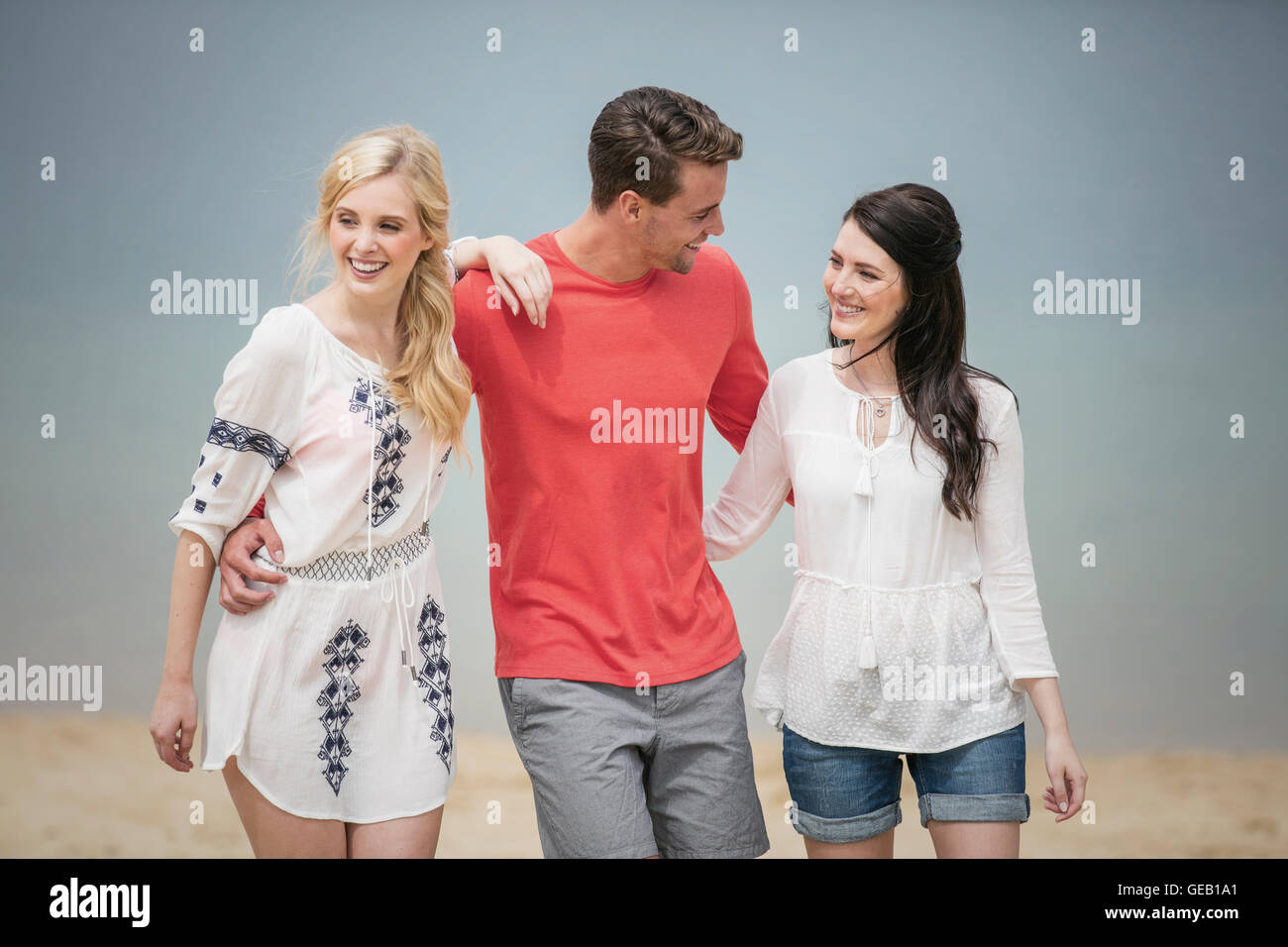 Three friends having fun on the beach Stock Photo - Alamy