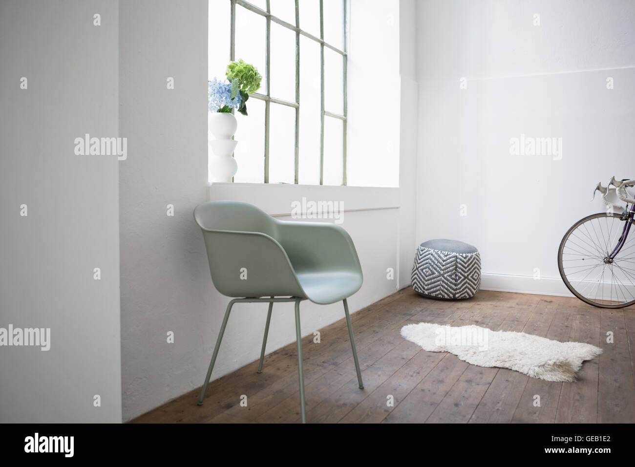 Modern home interior, chair and stool at window Stock Photo - Alamy