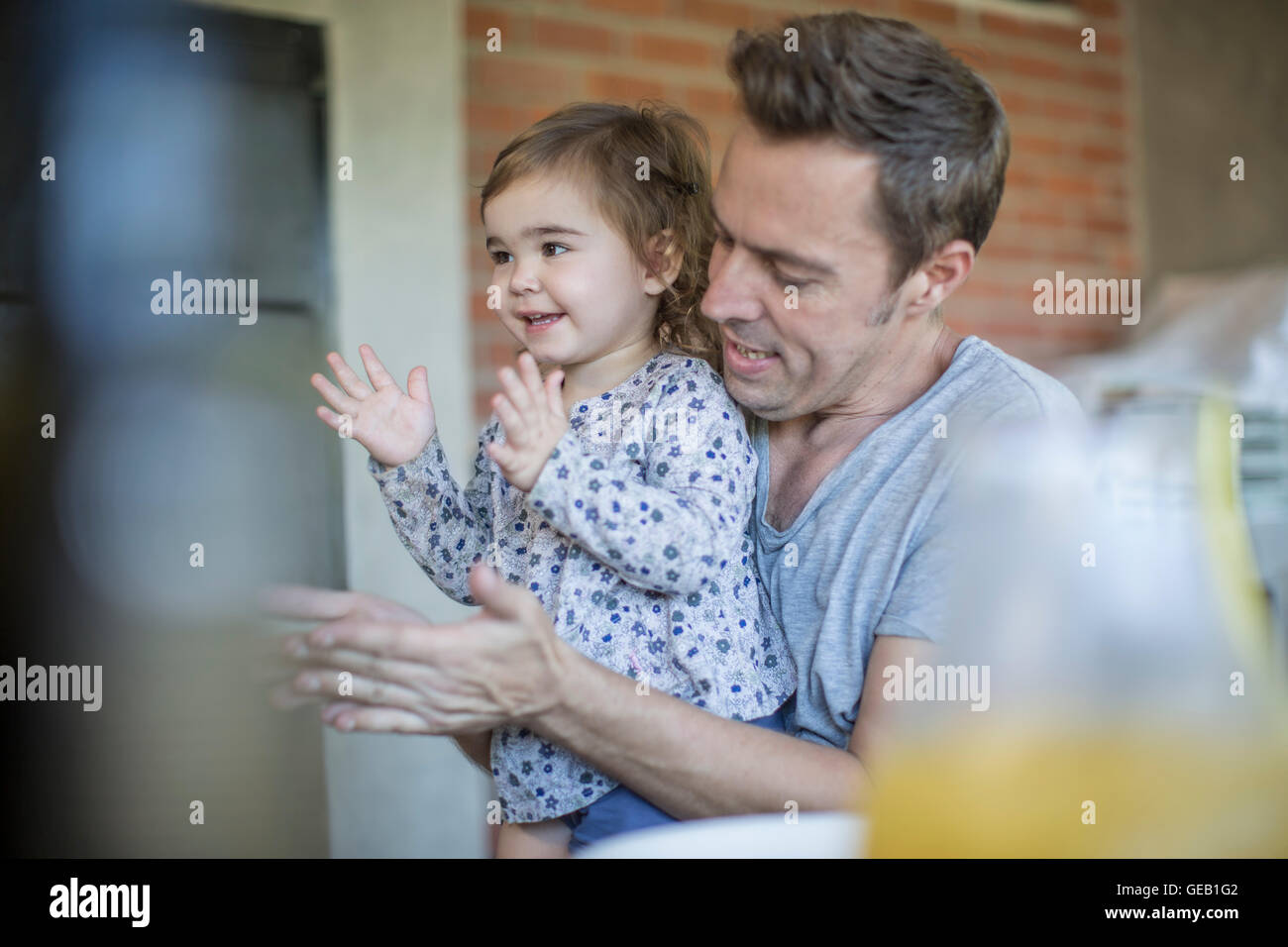 Father and little daughter clapping hands Stock Photo - Alamy