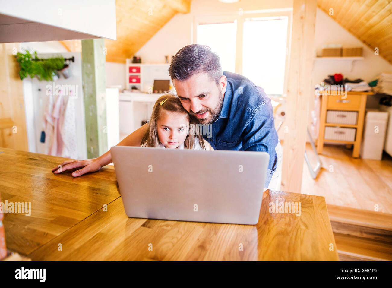 Father and daughter using laptop at home Stock Photo - Alamy