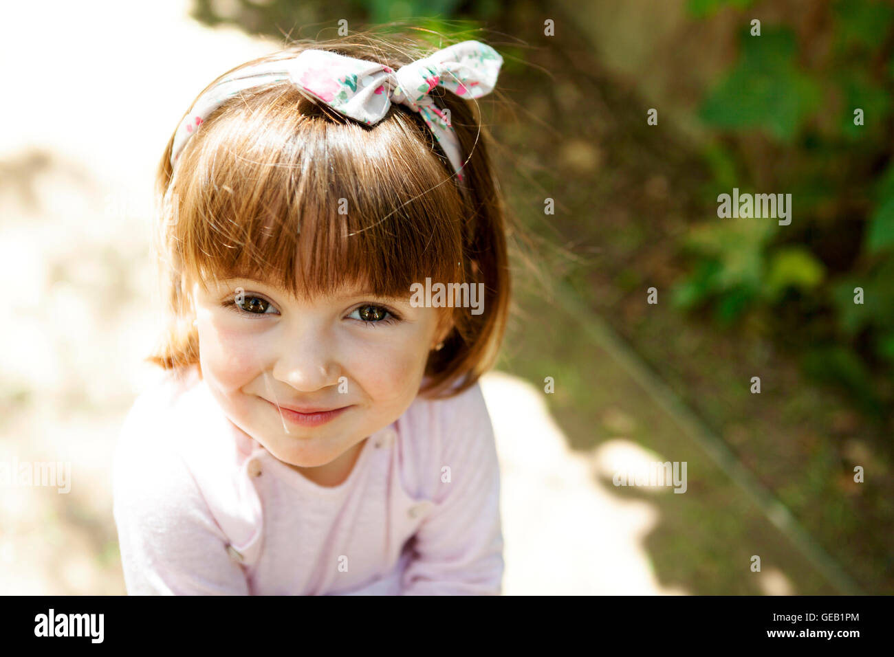 Portrait of smiling little girl with hair ribbon Stock Photo - Alamy