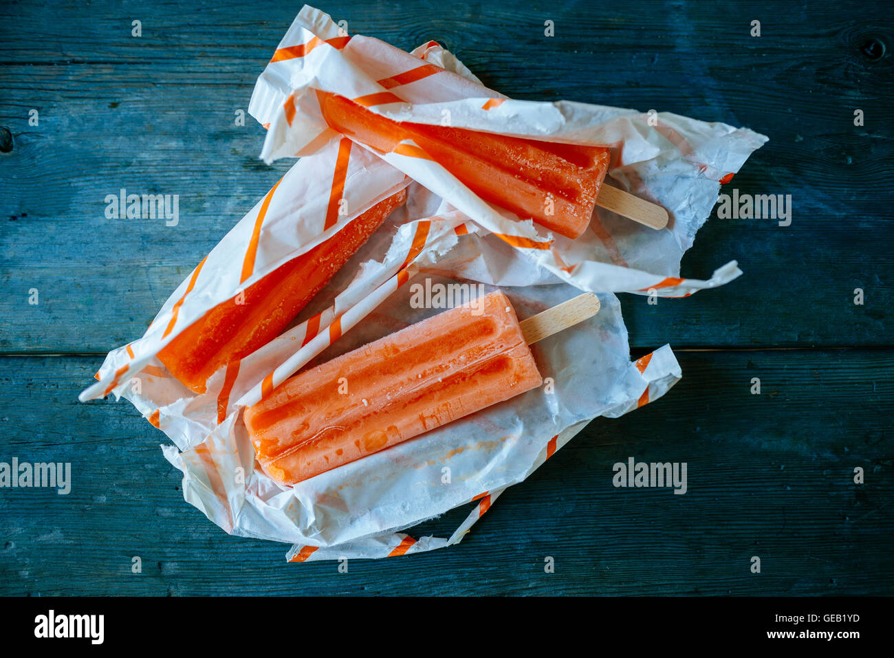 Orange snow ice cream in wrappings Stock Photo - Alamy