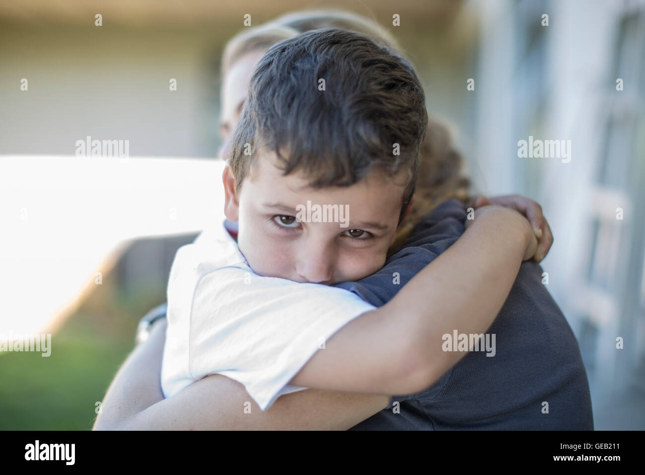 Portrait of sad little boy hugging his mother Stock Photo - Alamy